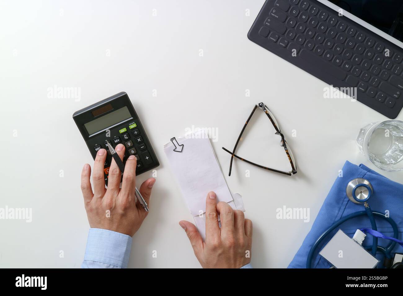 top view of Healthcare costs and fees concept.Hand of smart doctor used ...