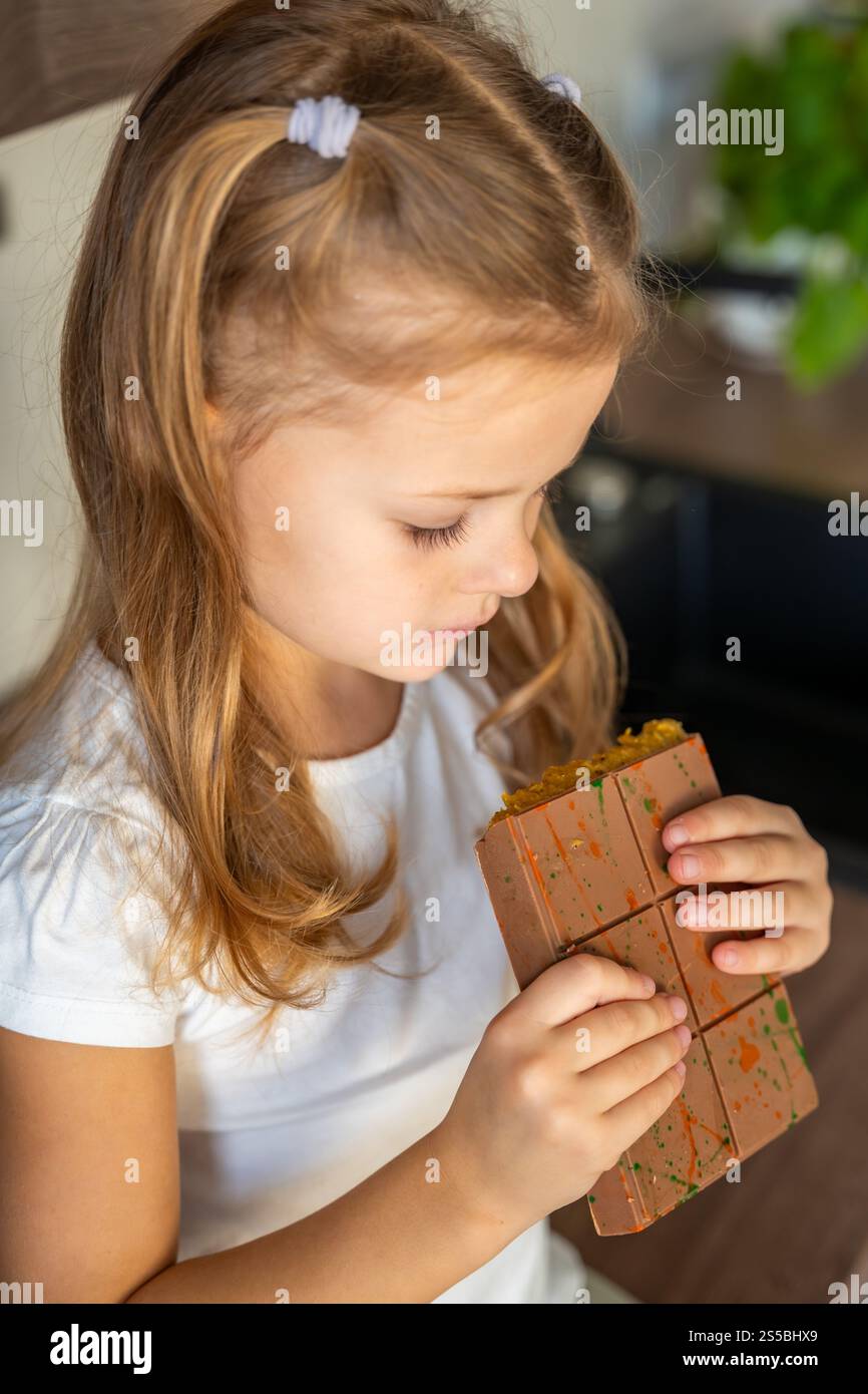Little girl eating Dubai chocolate with pistachio paste and kataifi ...