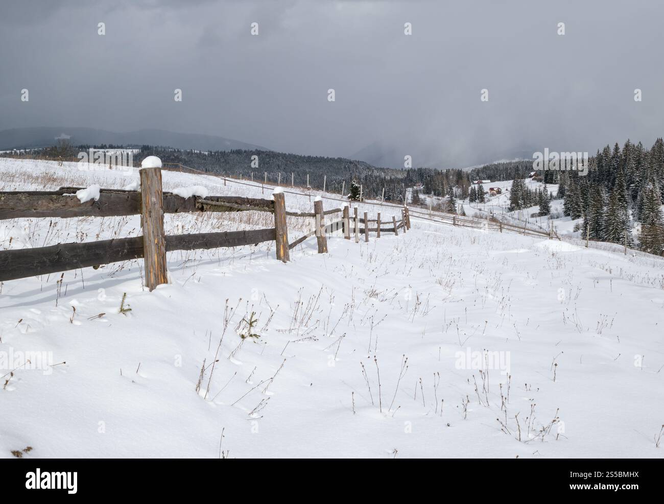Winter remote alpine mountain village outskirts, countryside hills ...