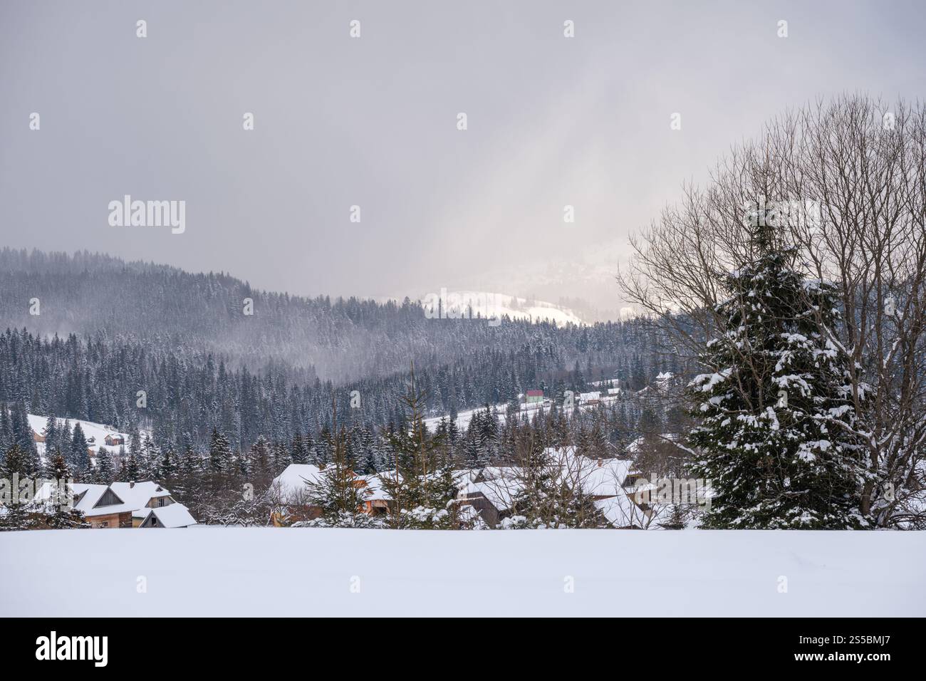 Winter remote alpine mountain village outskirts, countryside hills ...