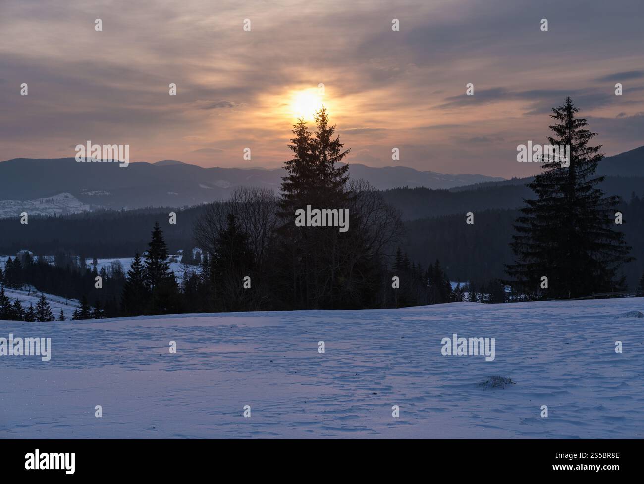 Small alpine village and winter snowy mountains in first sunrise ...