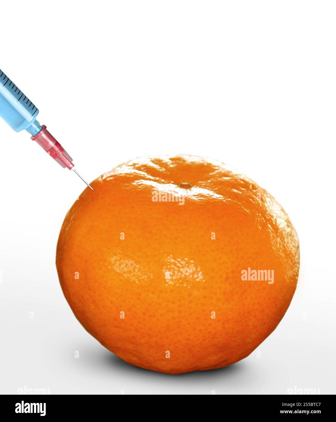 syringe sticked into orange,GMO isolated on a white background. syringe ...