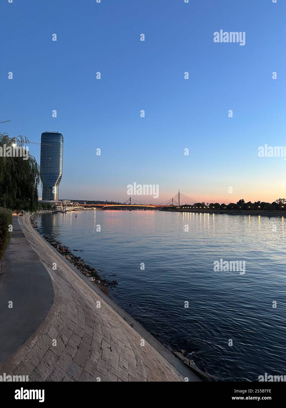 Riverside view at sunset in Belgrade, showcasing modern architecture ...