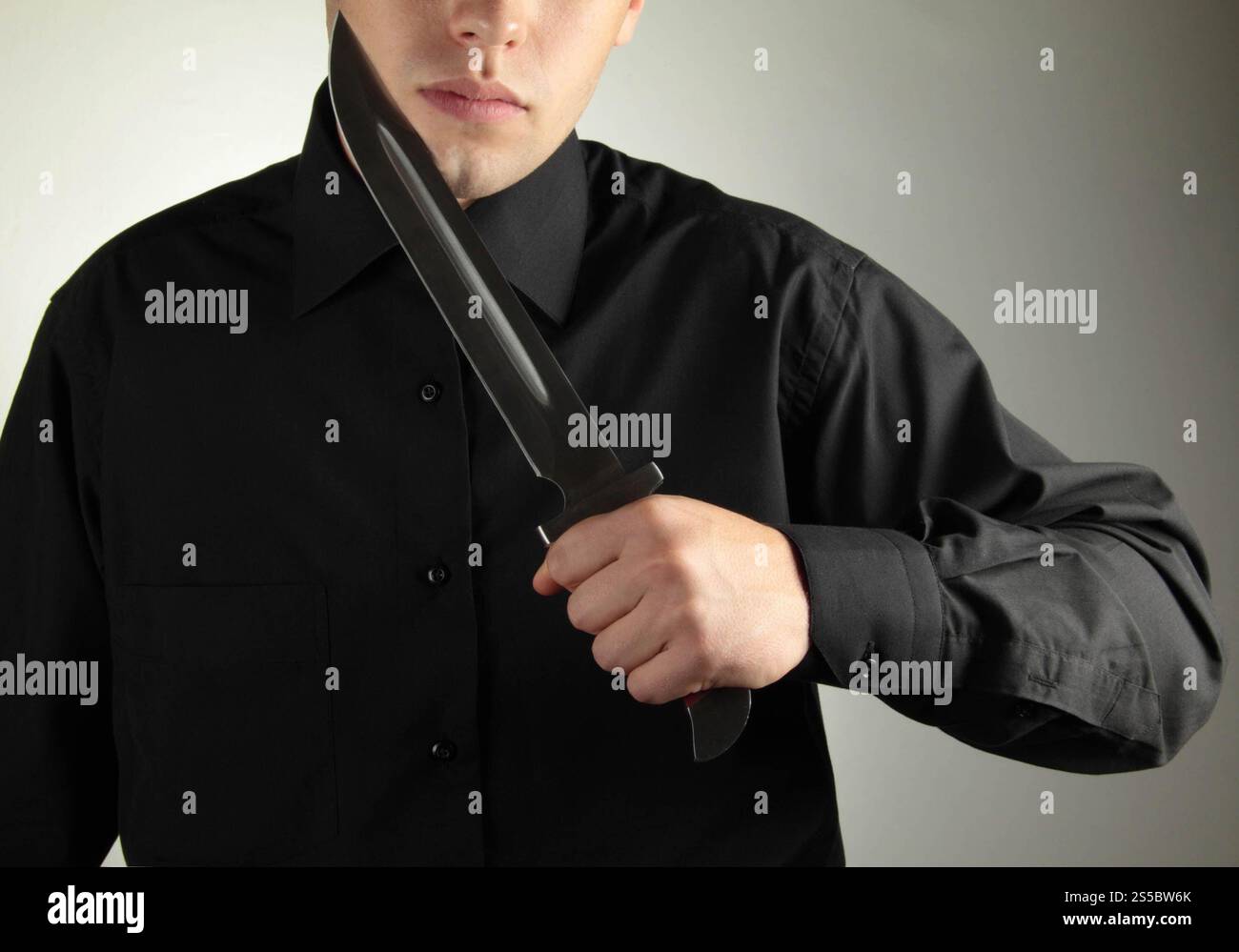 standing man in black with knife isolated on white background. standing ...