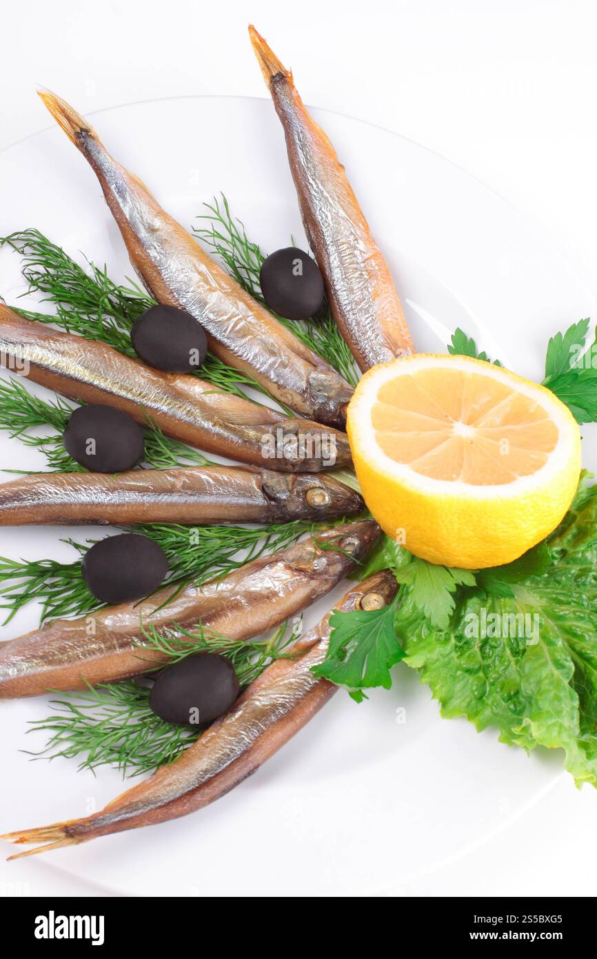kipper fish on composition with vegetables isolated on white background ...
