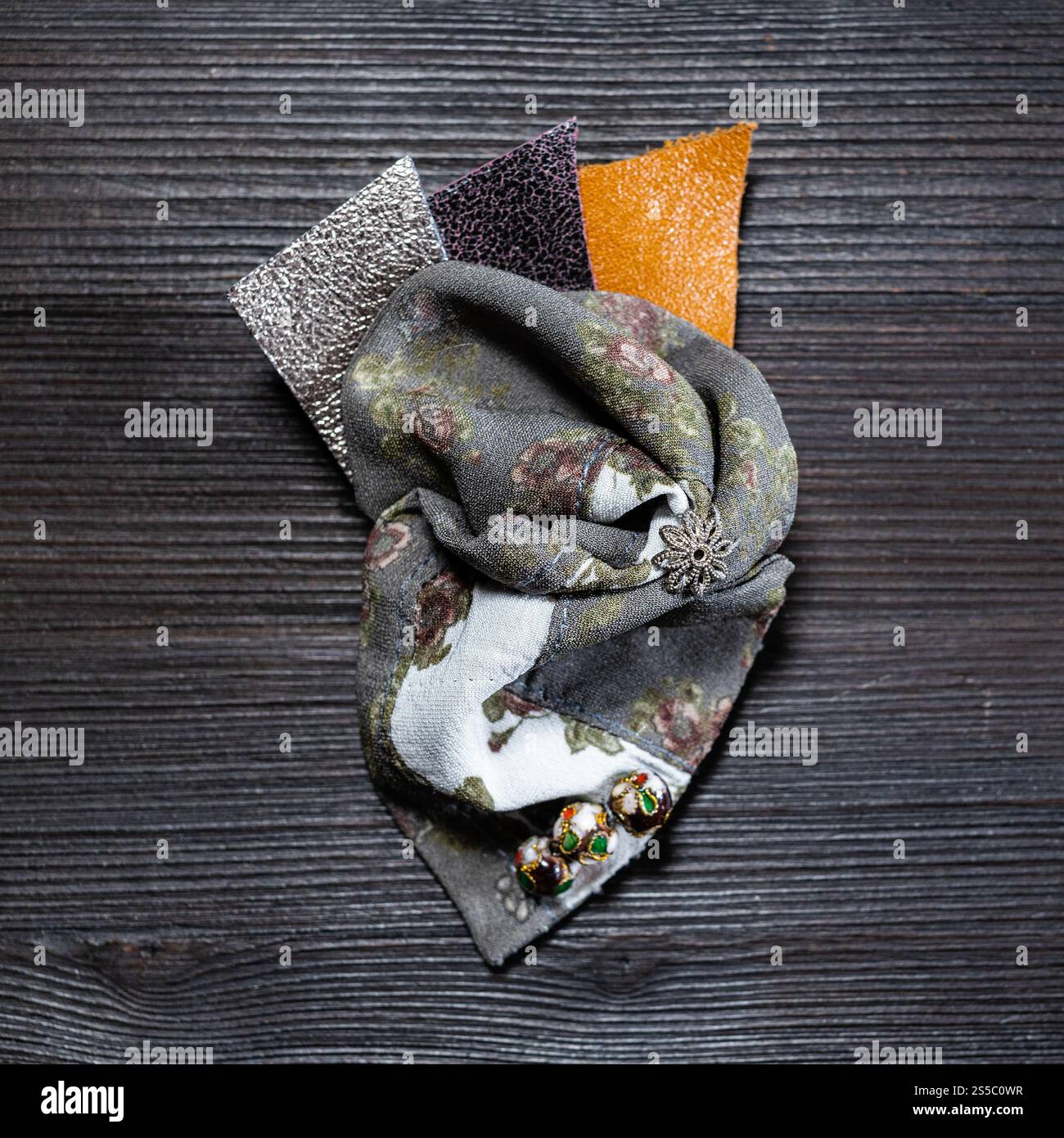 top view of handcrafted silk and leather brooch decorated with ...