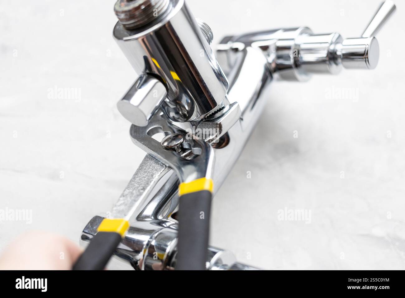 shower faucet assembly by adjustable wrench on concrete board close up ...