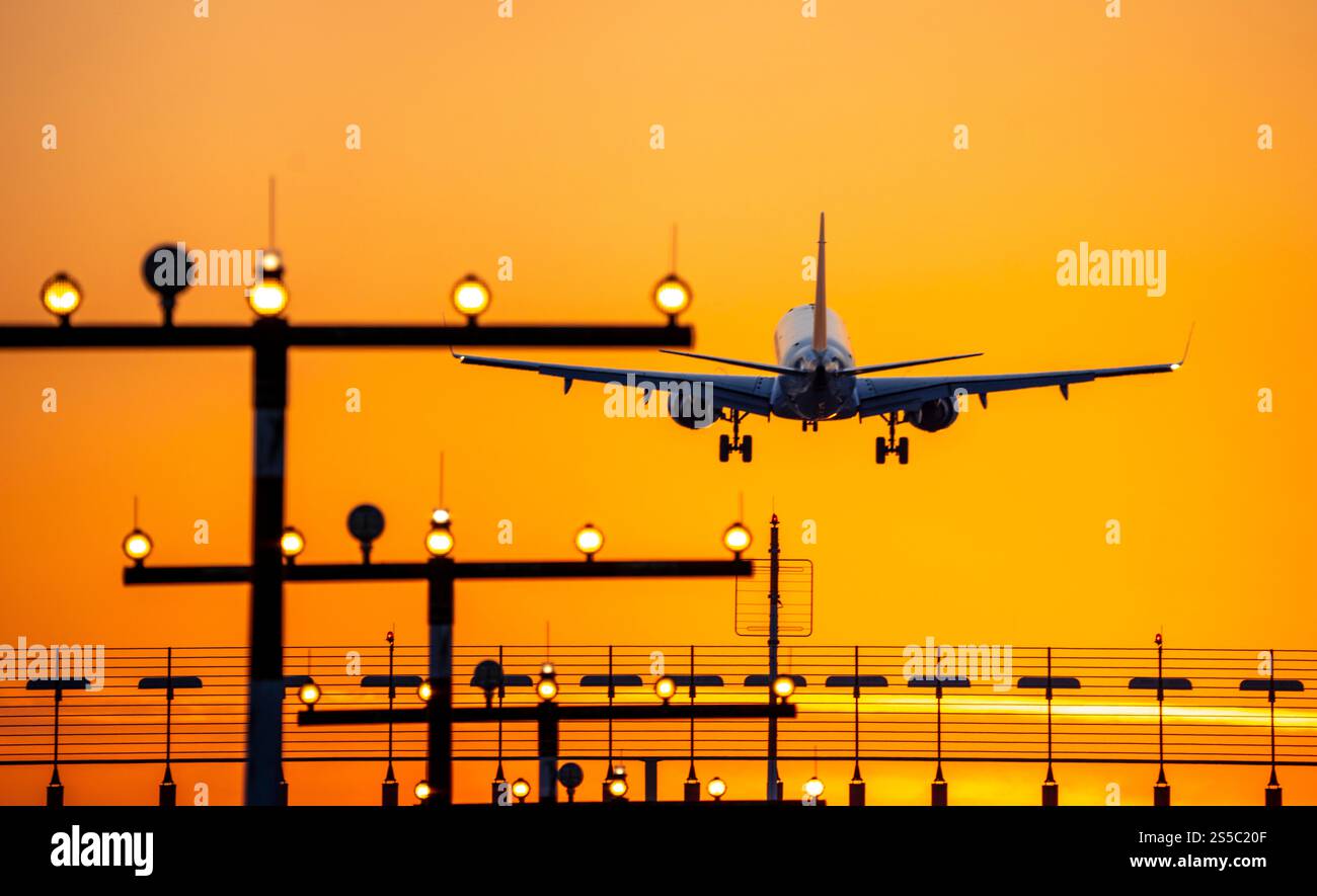 Aircraft on approach to the main south runway, 05R/23L, runway lighting ...
