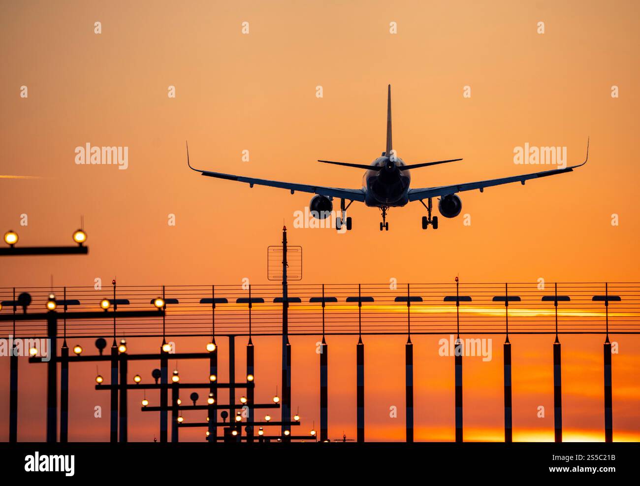 Aircraft on approach to the main south runway, 05R/23L, runway lighting ...