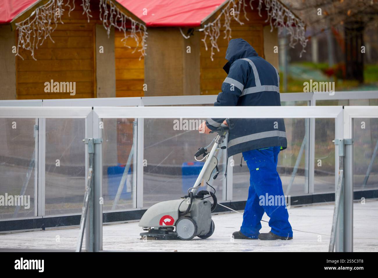 Man with an ice polishing machine on an ice rink Stock Photo - Alamy