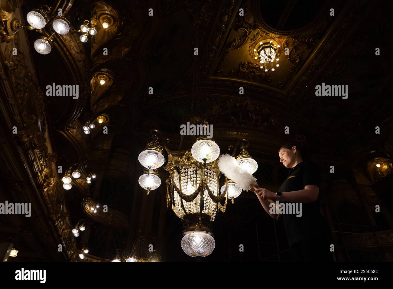 Tower ballroom team member Jennifer Allinson cleans one of the twelve ...