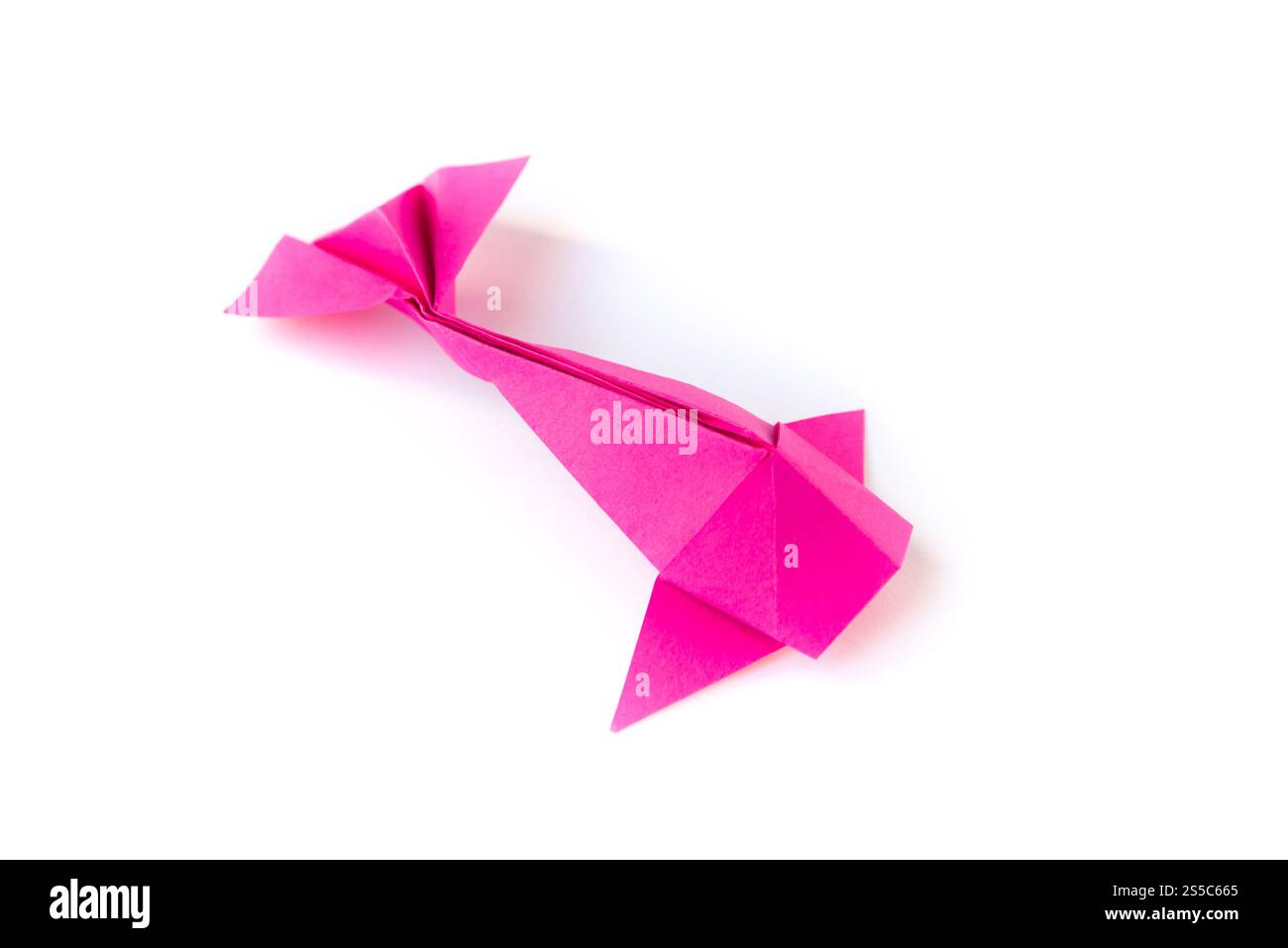 Pink paper fish origami isolated on a blank white background. Pink ...