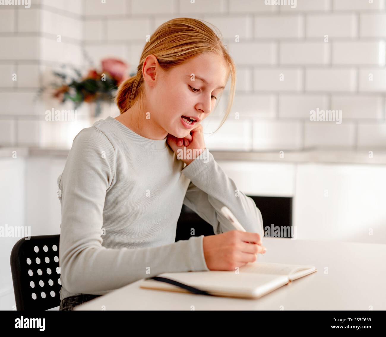 Cute Little Girl Doing Homework And Thinking About The Task Stock Photo ...