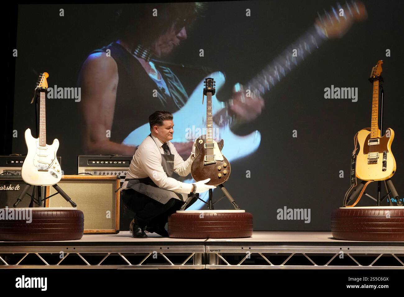 An art handler displays a displays a Gibson, Kalamazoo, Michigan, 1954 ...
