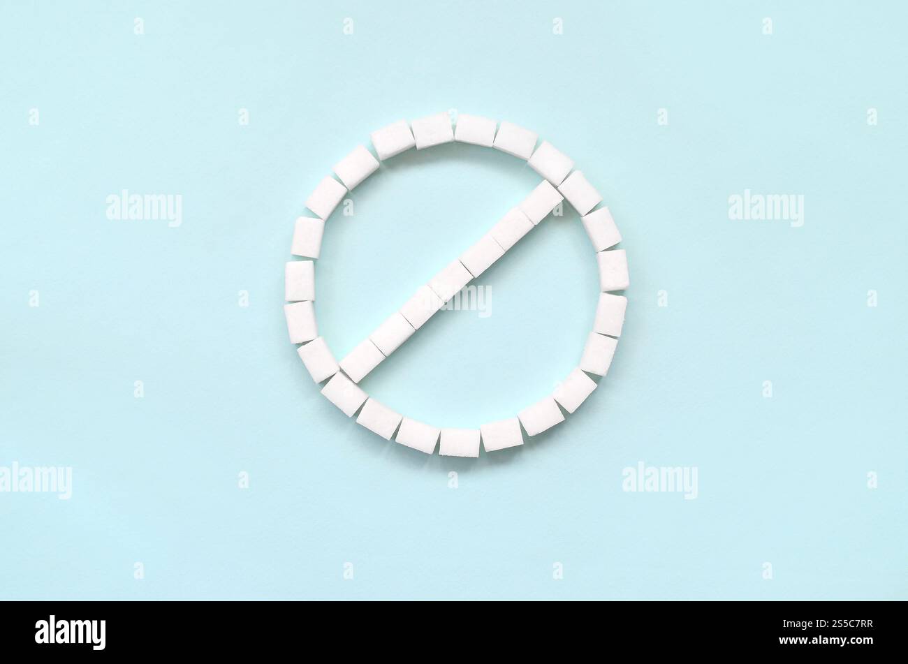 Sign of the ban of sugar cubes on a pastel blue background. Diabetic ...
