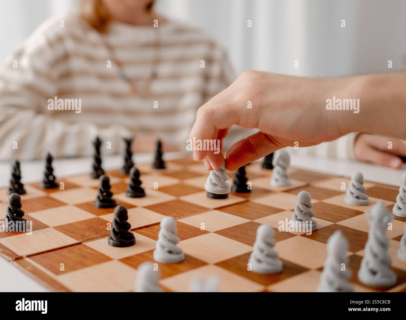 Little Girl Has A Game Of Chess At Home, father hand holds a chess ...