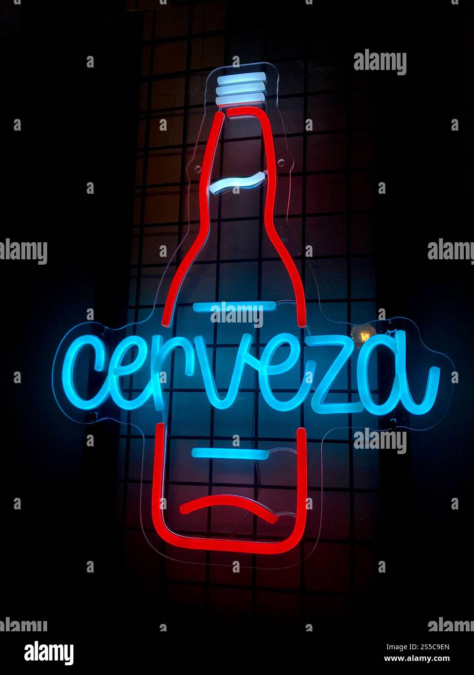 A neon sign of a bottle of Cerveza. The bottle is lit up in red and ...