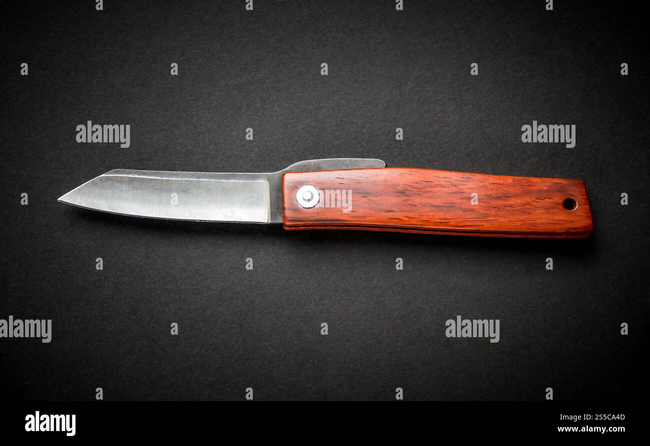 Traditional japanese higonokami pocket knife isolated on black ...