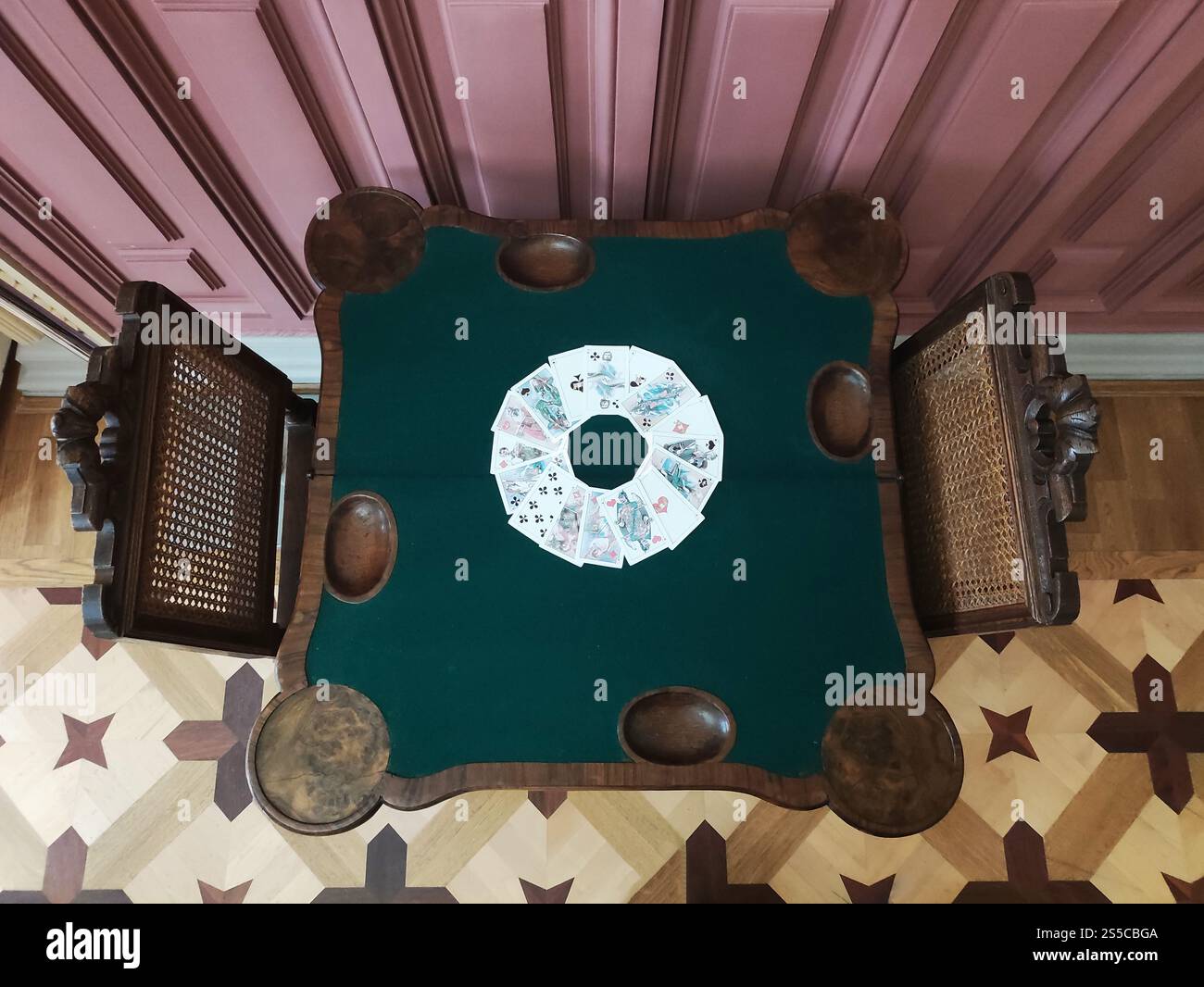Green cloth on the table with cards. Antique fun with board games in ...