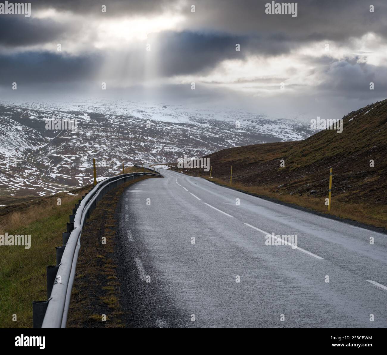 Highway road and mountain view with sun rays through clouds during auto ...