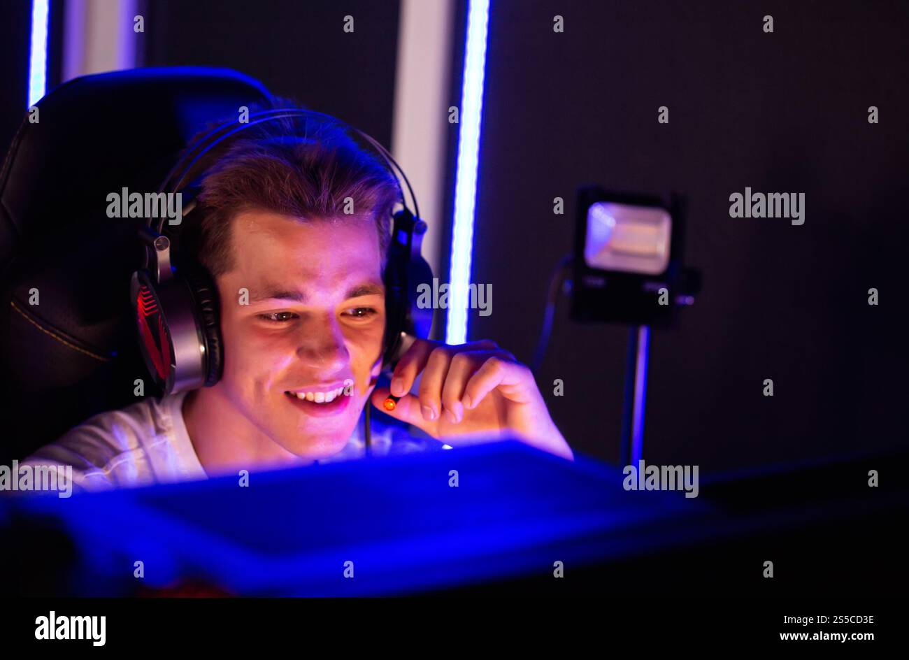 Joyful gamer emotionally plays tight arcade racing, facial expressions ...