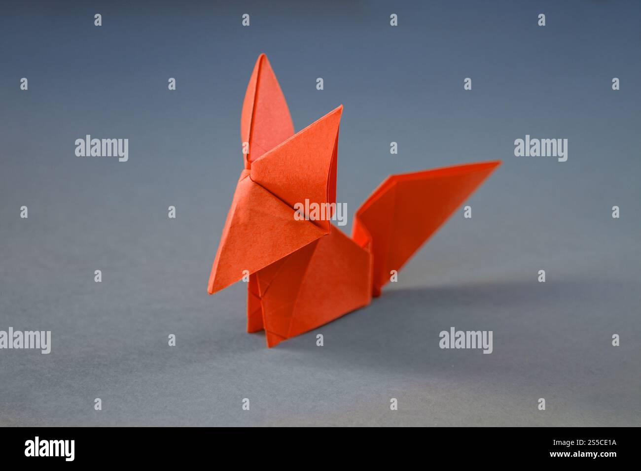 Orange paper fox origami isolated on a blank grey background. Orange ...