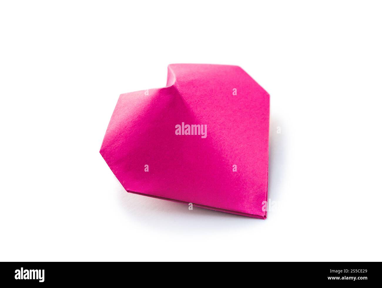 Pink paper heart origami isolated on a blank white background ...