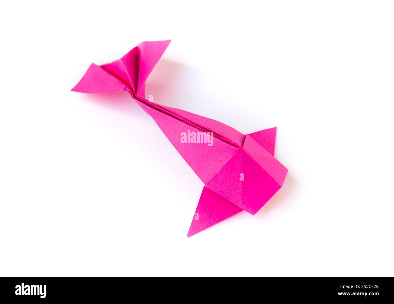 Pink paper fish origami isolated on a blank white background. Pink ...