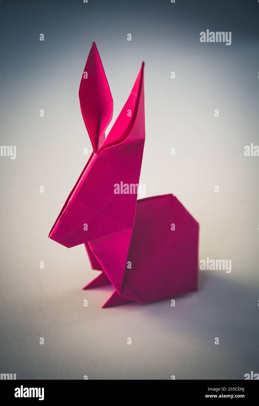 Pink paper rabbit origami isolated on a blank background. Pink paper ...