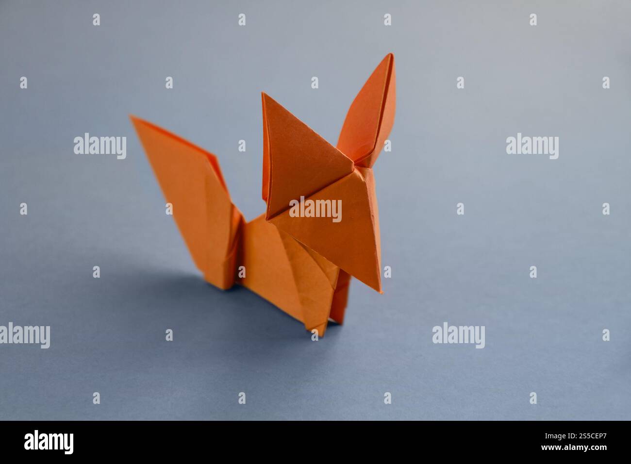 Orange paper fox origami isolated on a blank grey background. Orange ...