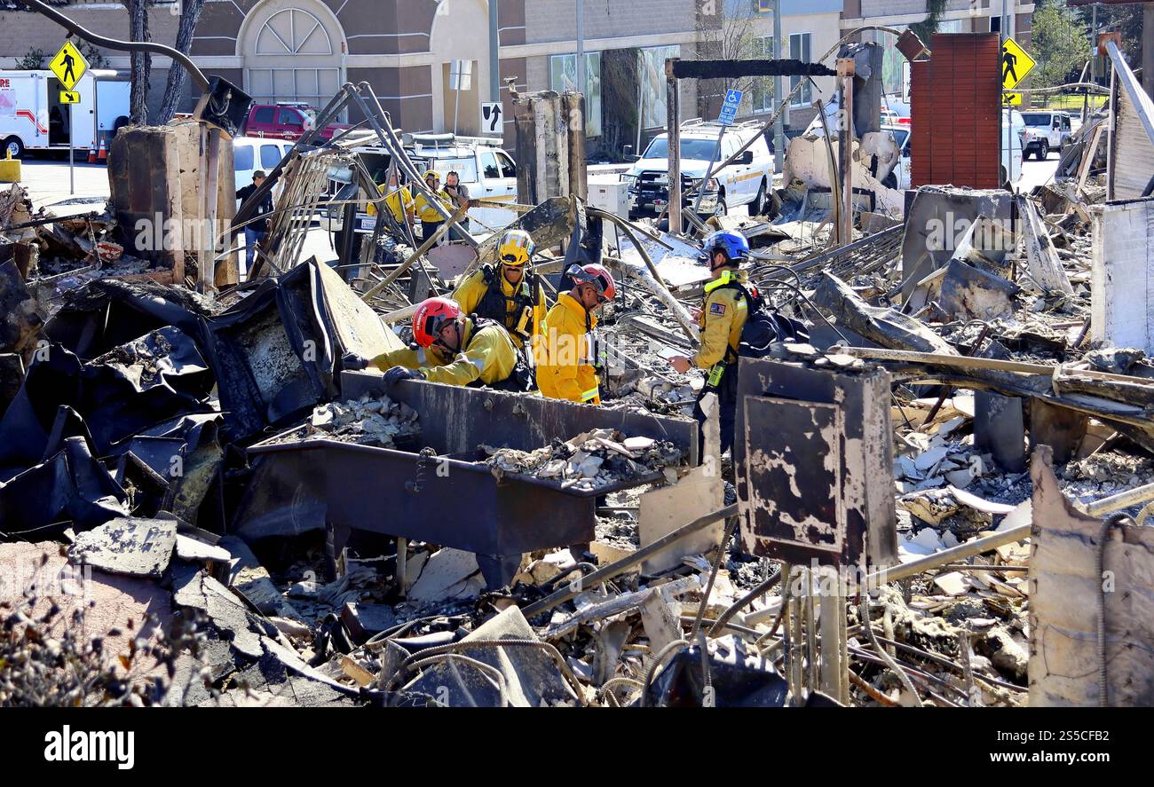 Firefighters and investigators search for missing people in a building ...