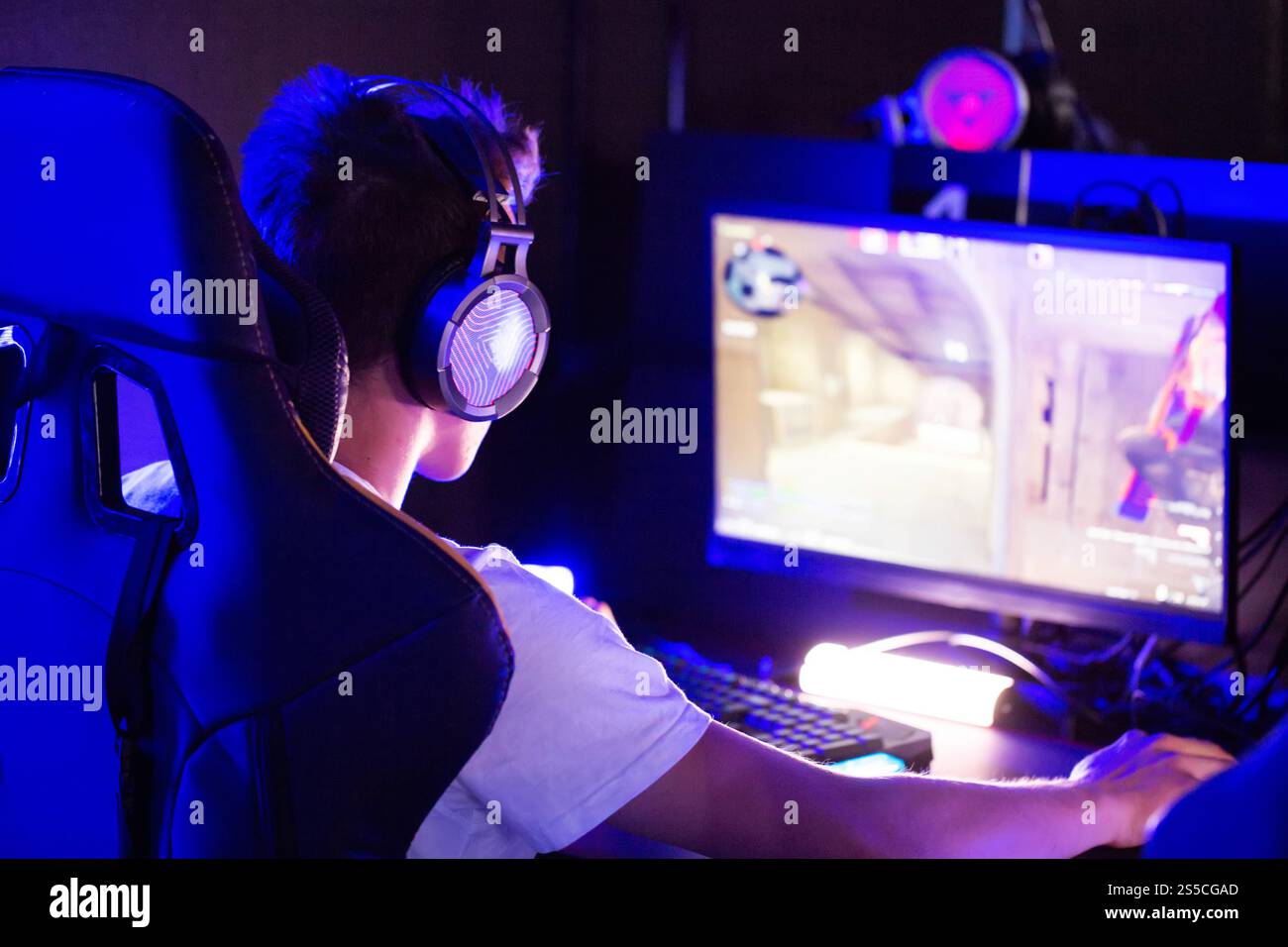 Professional gamer is playing a computer game on PC at cyber club ...