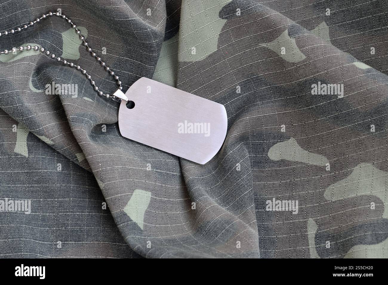 Silvery military beads with dog tag on camouflage fatigue uniform. Army ...