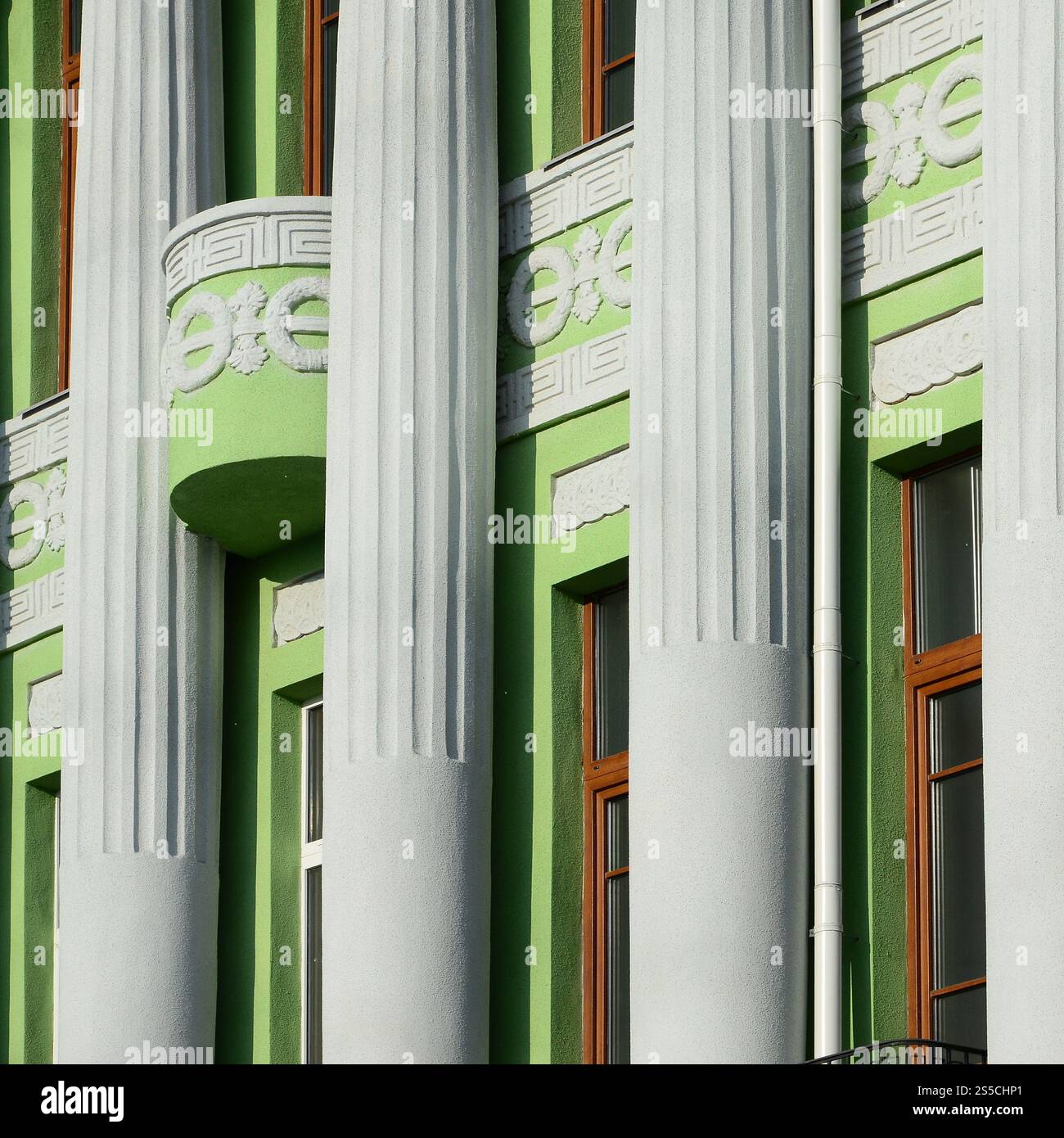 Restored old multi-storey building with antique columns, painted in ...