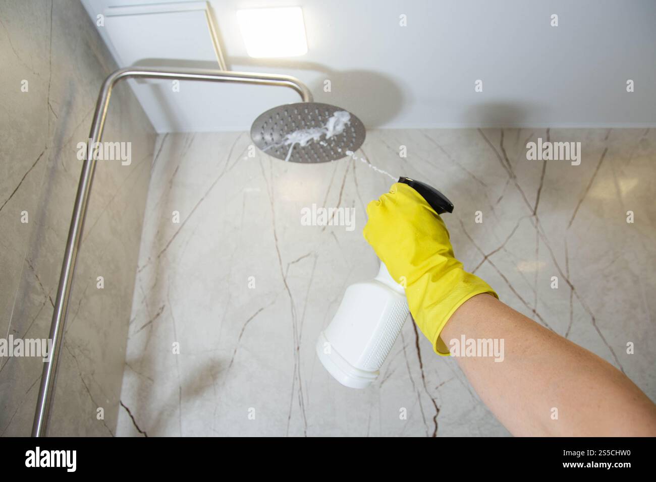Washing the shower head in the bathroom with a cleaning and bleaching ...