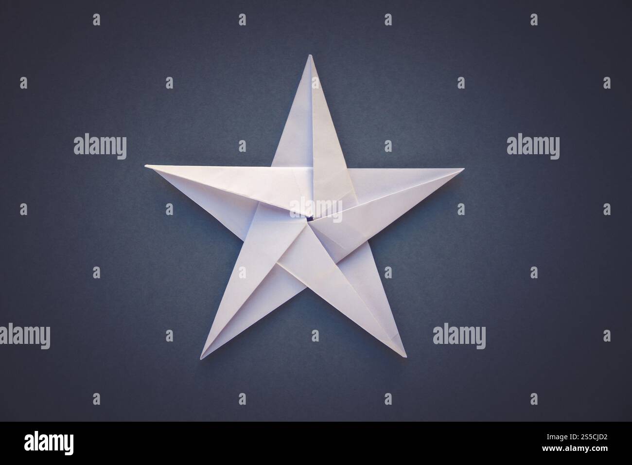 White paper star origami isolated on a blank grey background Stock ...
