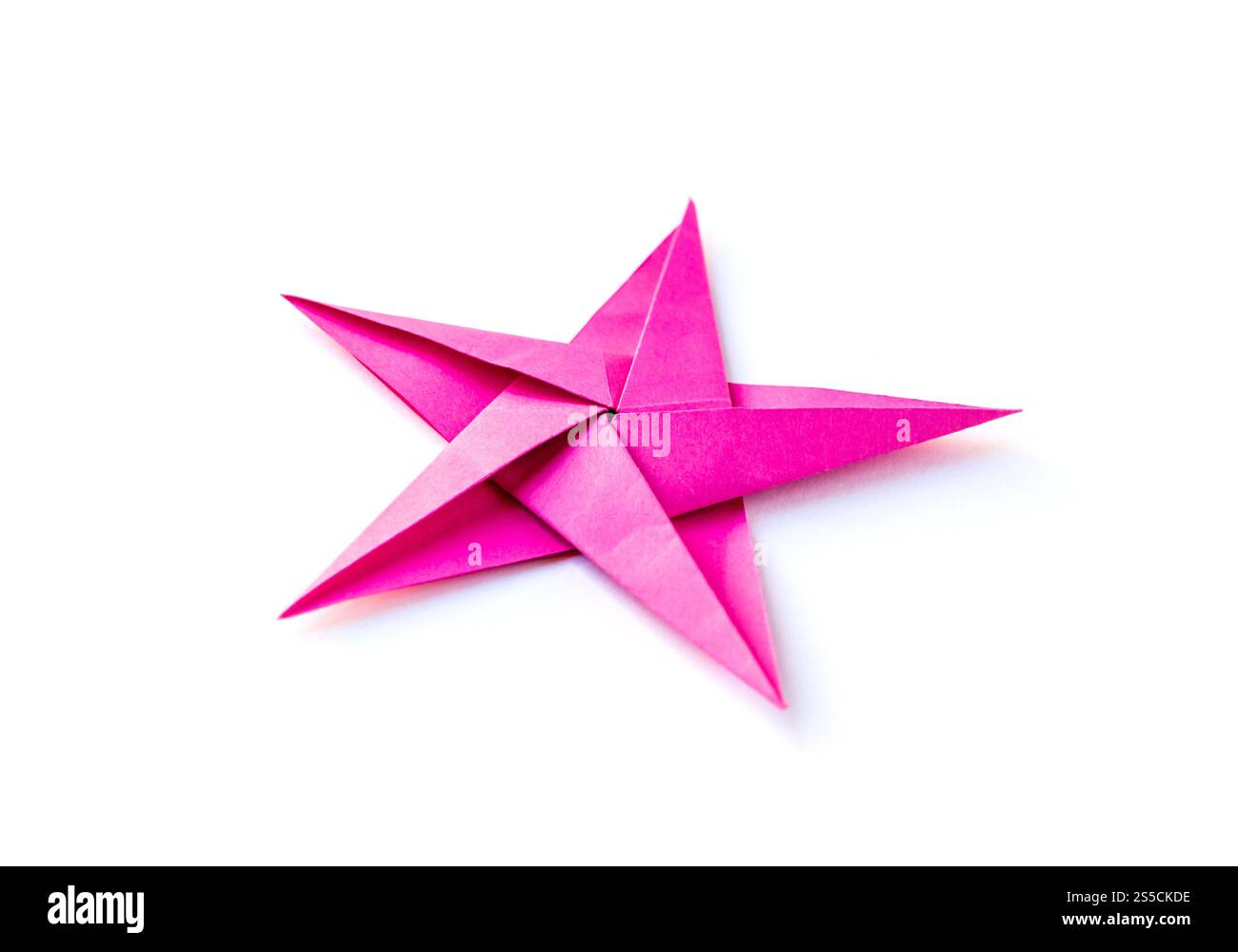 Pink paper star origami isolated on a blank white background. Pink ...