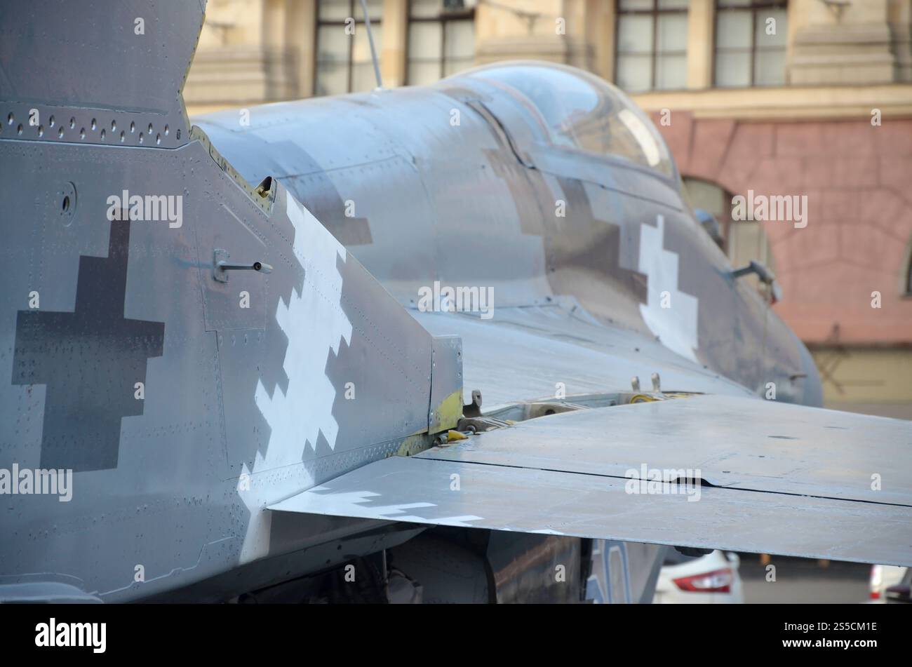 Old fighter aircraft painted in grey camouflage shapes with many small ...