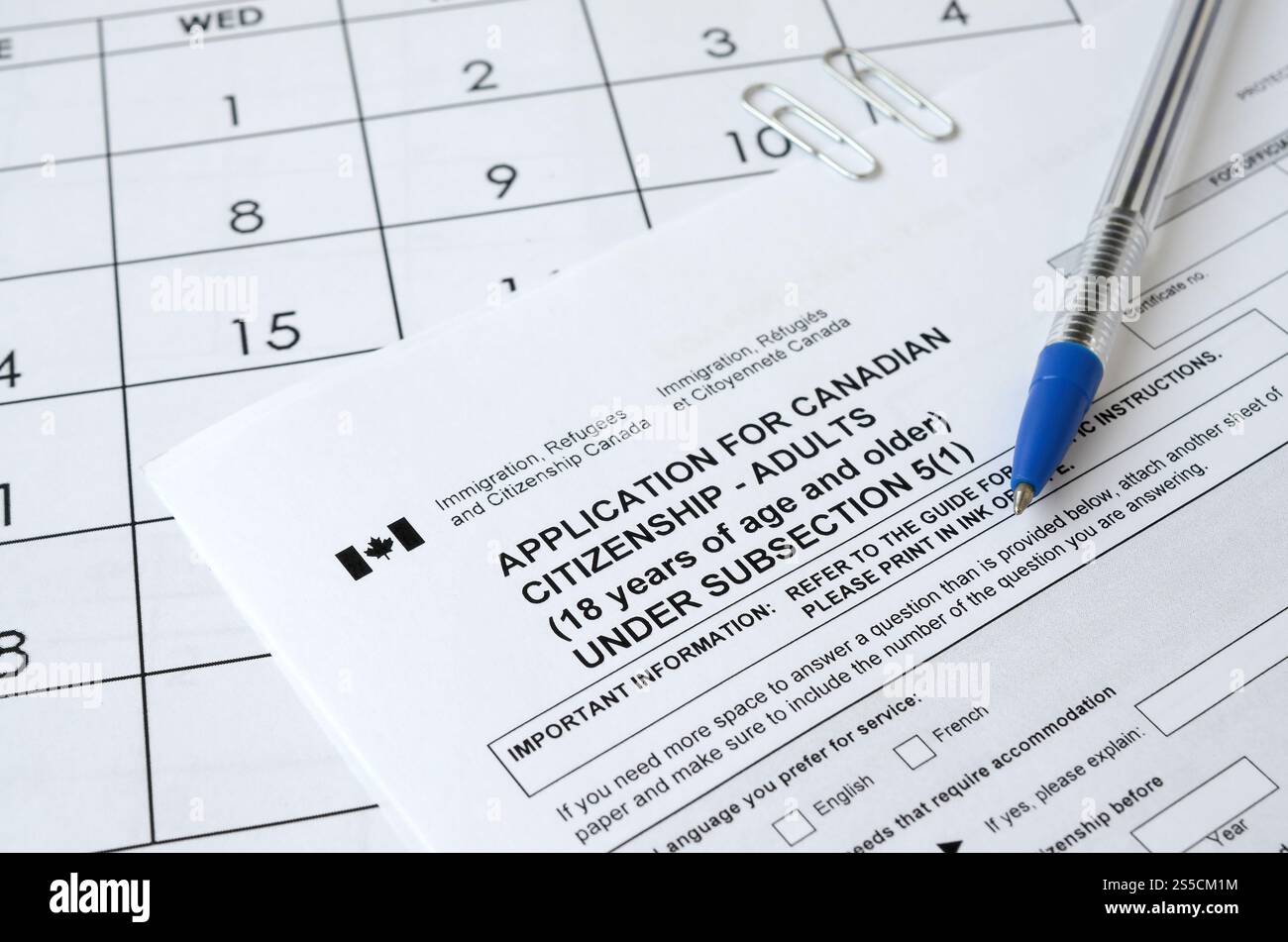 Application for Canadian citizenship for adults and blue pen lies on ...