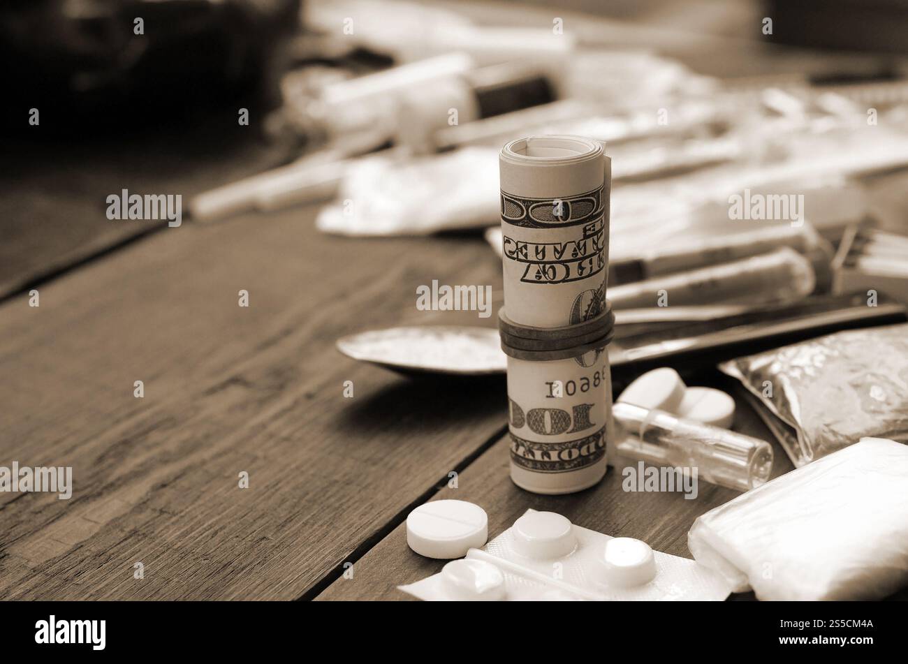 Roll of hundred dollar bills on background of narcotic drug dealer ...