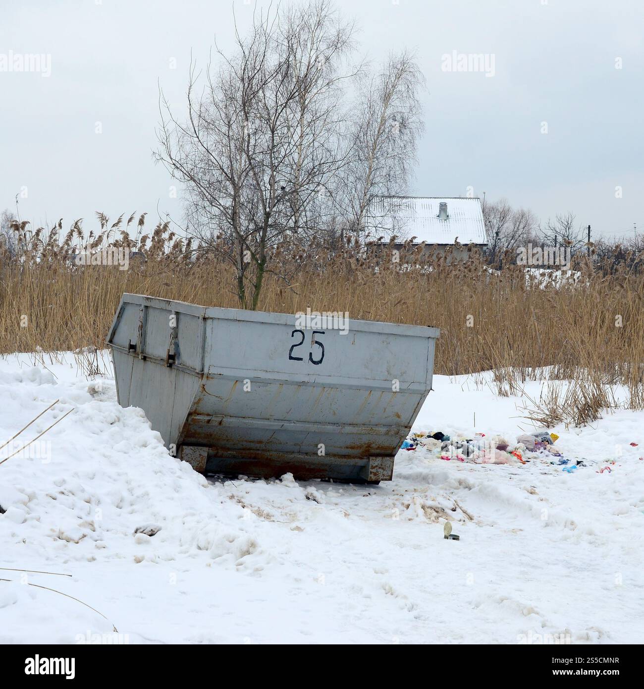 Trash bin at the side of street in winter with lip garbage container ...