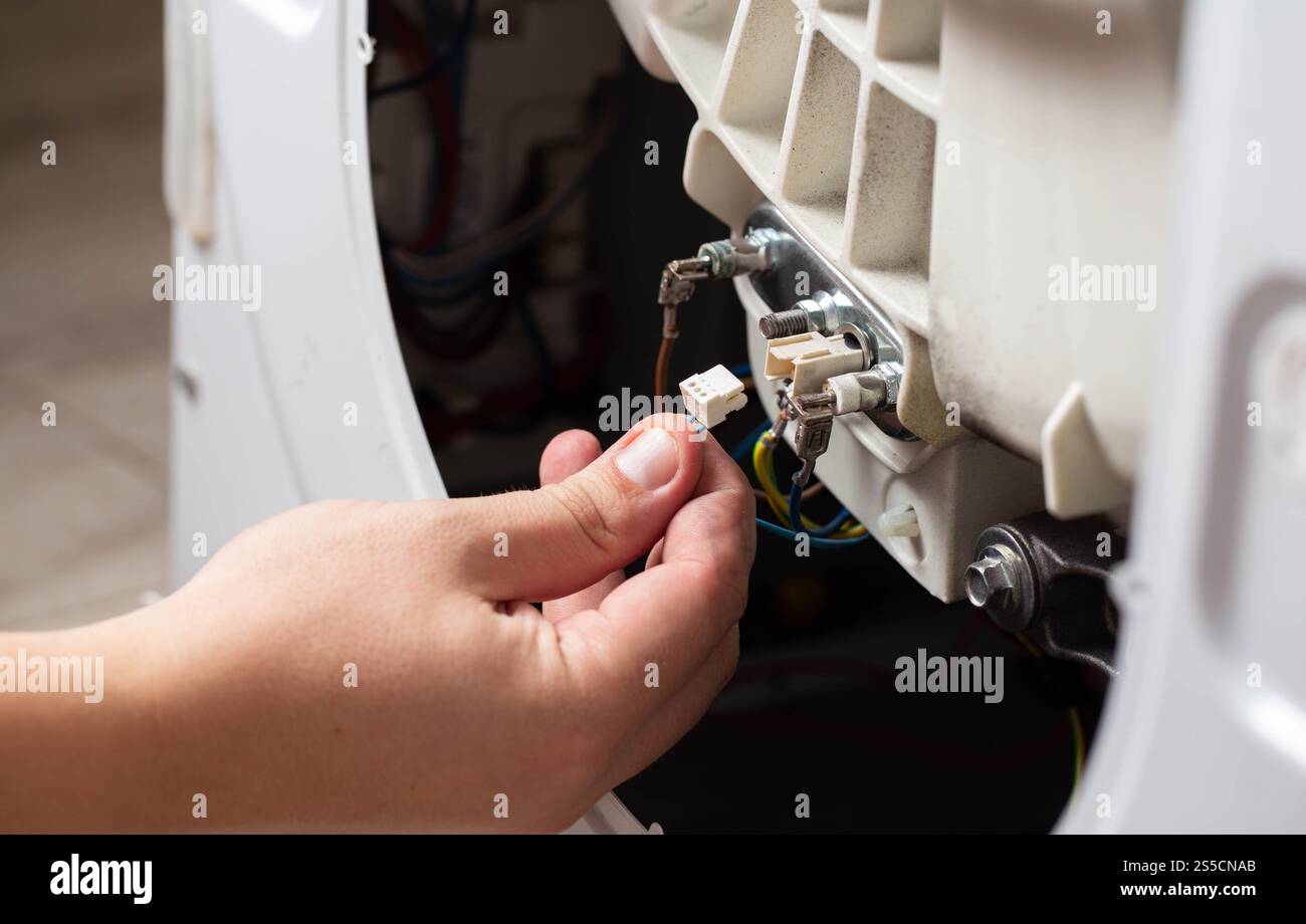 The hand of the master disconnects the electrical chip from the ...