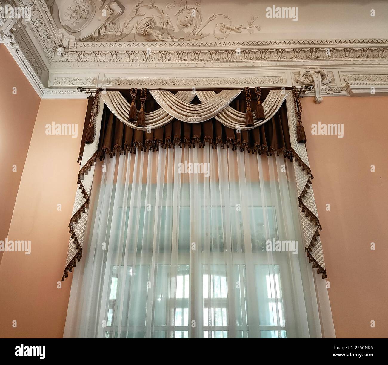 An old window with a curtain and a stucco ceiling, interior of an ...