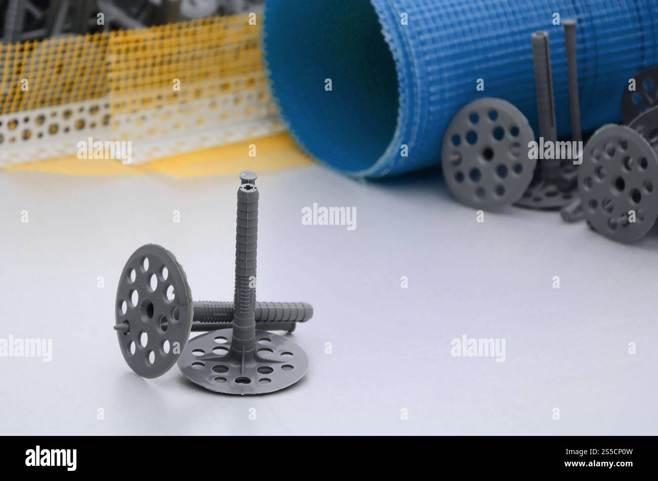 A set of construction items for the insulation of walls. Plastic dowels ...