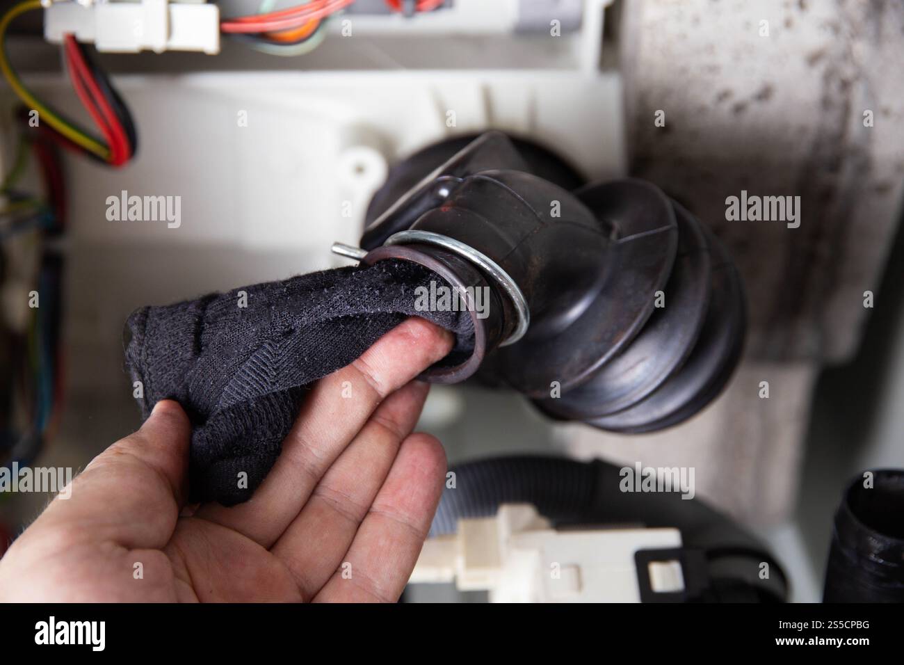 The rubber drain pipe and drain pump are clogged with clothes in the ...