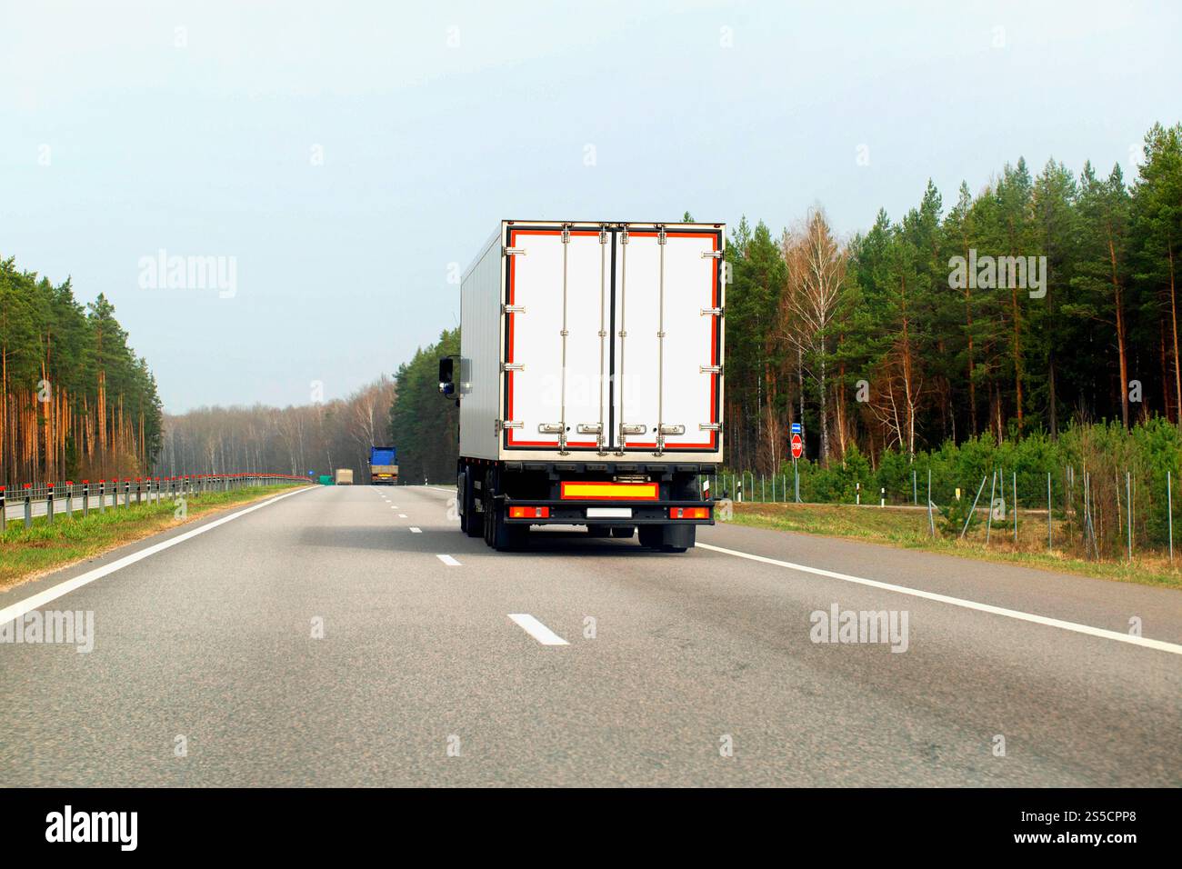 A new truck with a white isothermal semi-trailer transports a load of ...