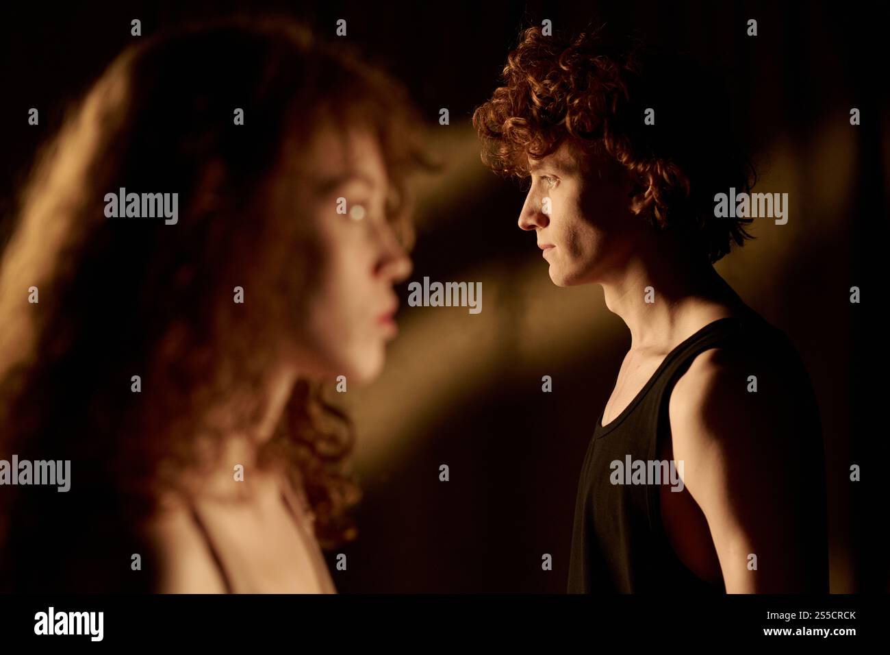 Side view of curly haired Caucasian couple looking in different ways ...