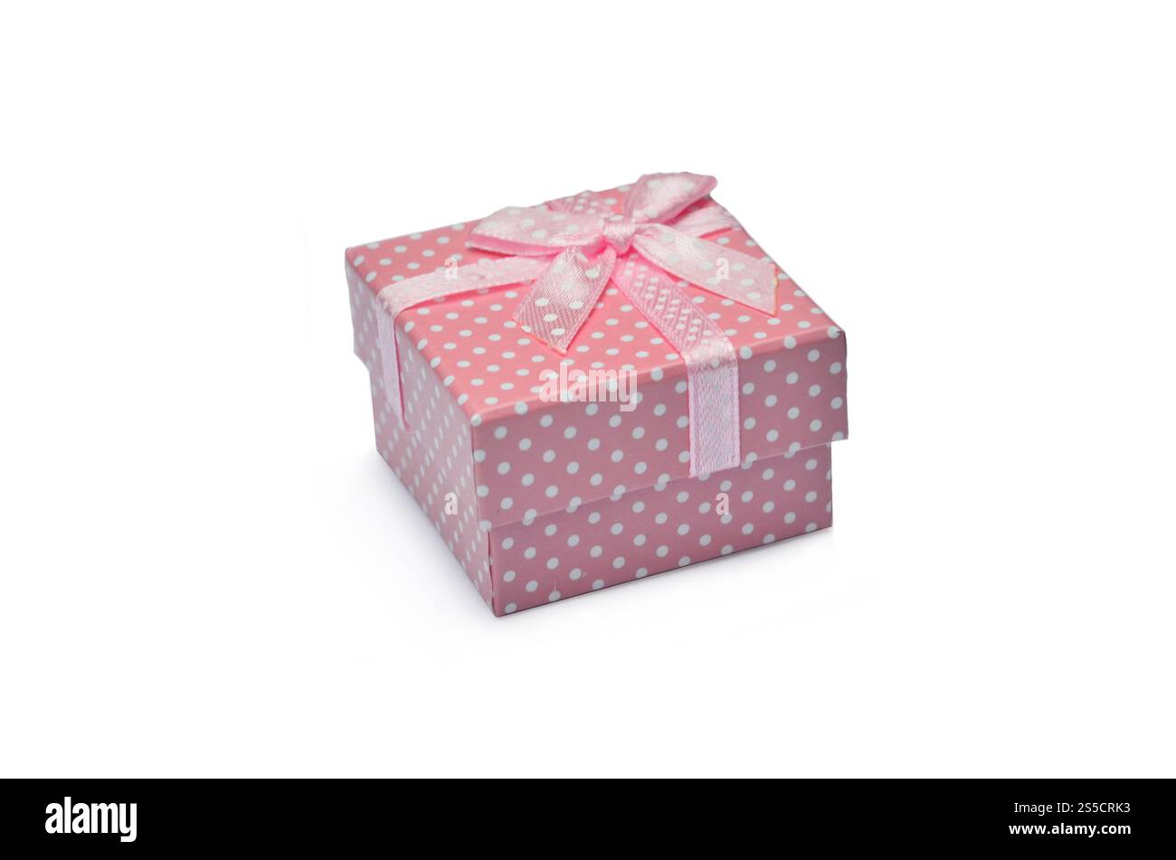 Pink dotted mini present-box with ribbon isolated on white background ...