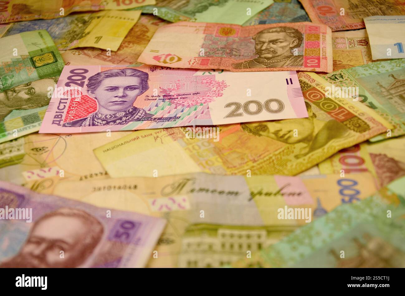 Background image of many Ukrainian banknotes of different colors and ...