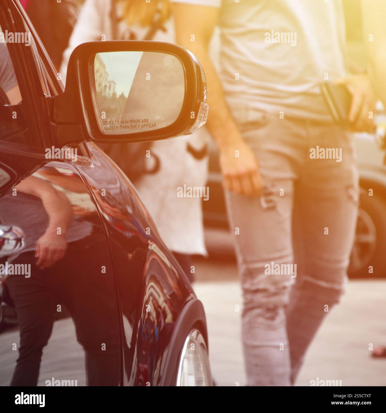 Diagonal view of a black glossy car with white wheels, which stands on ...